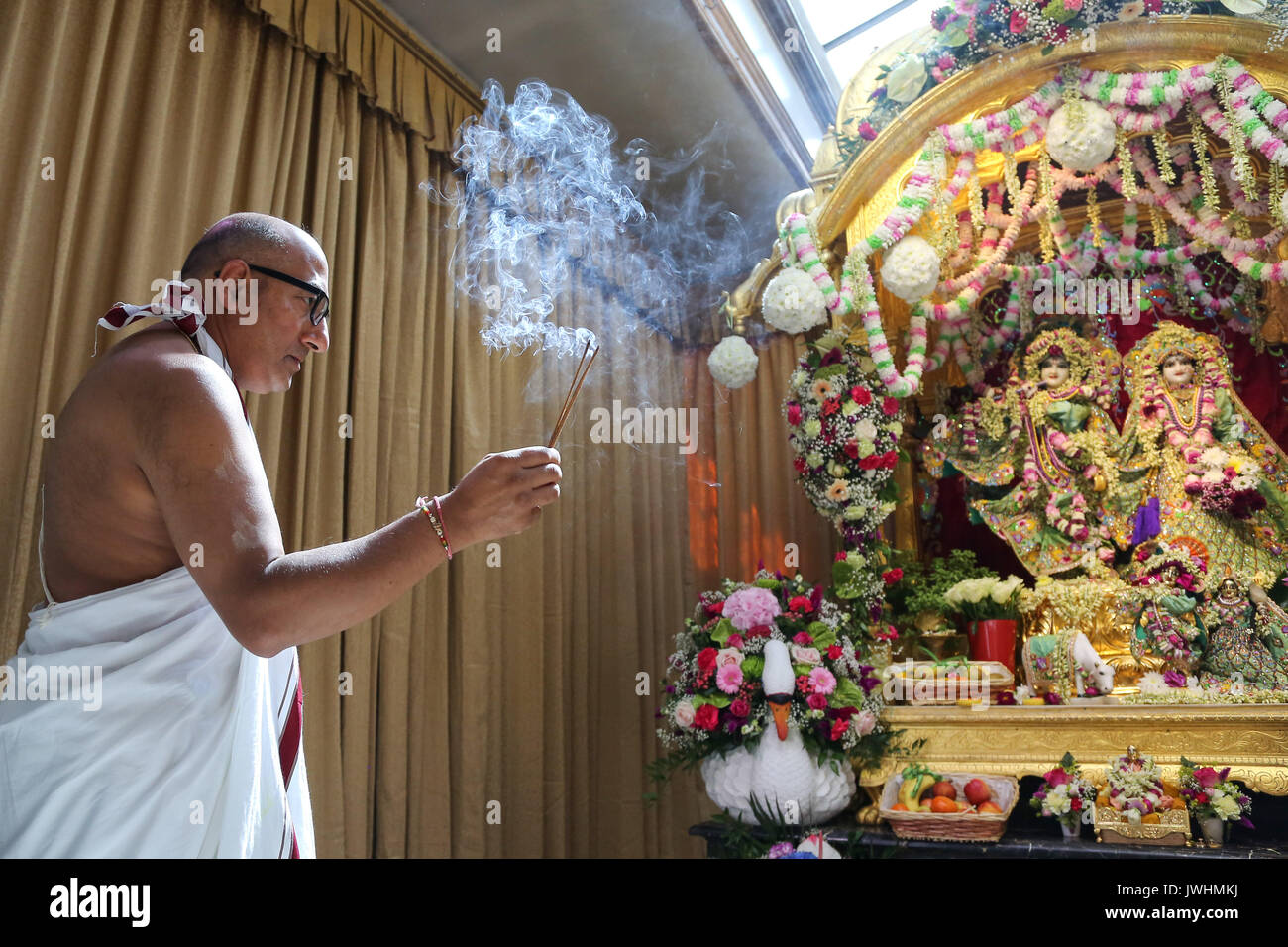 Watford, UK. 13th August, 2017. The priest conducts an aarti at ...