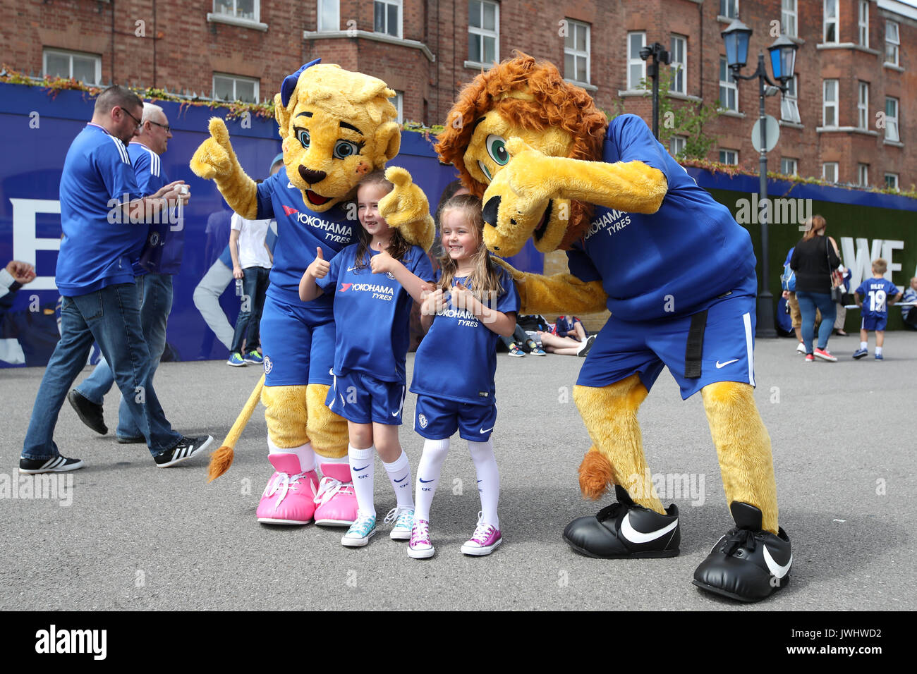 Young Chelsea supporters pose with Chelsea mascots Stamford the Lion ...