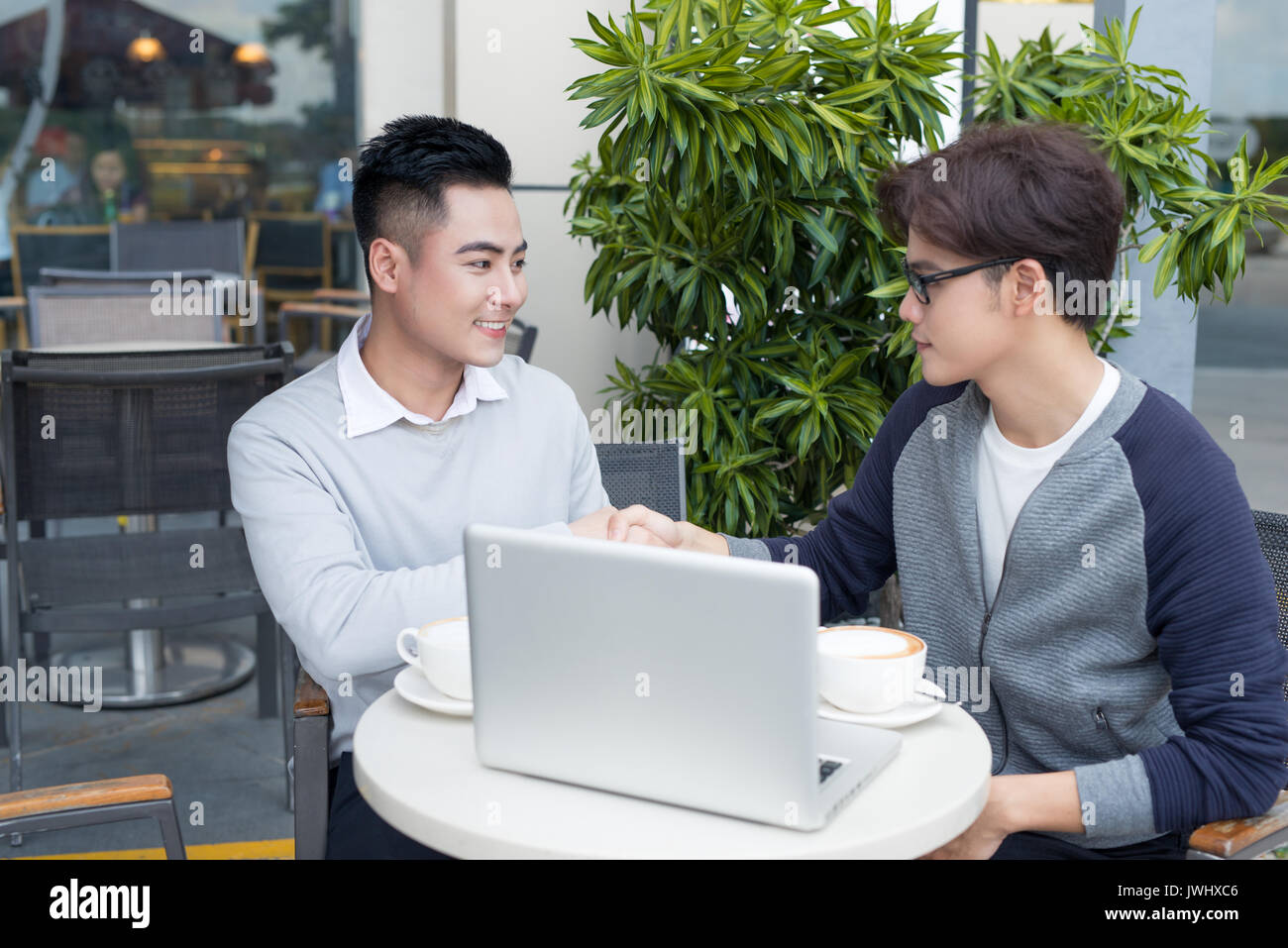 Two young businessman having successful hi-res stock photography and ...