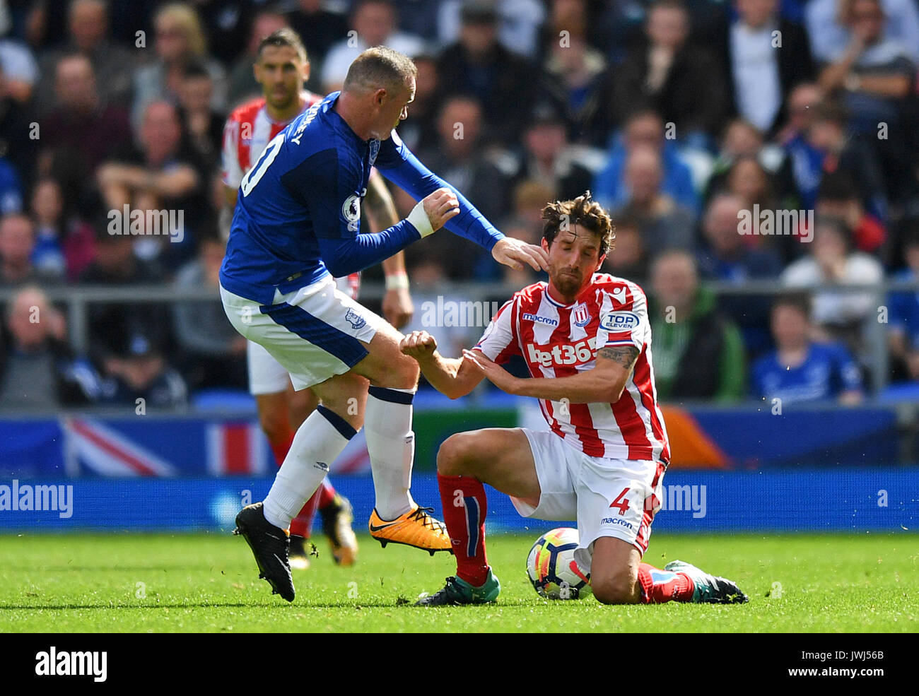 Everton's Wayne Rooney (left) and Stoke City's Joe Allen in action ...