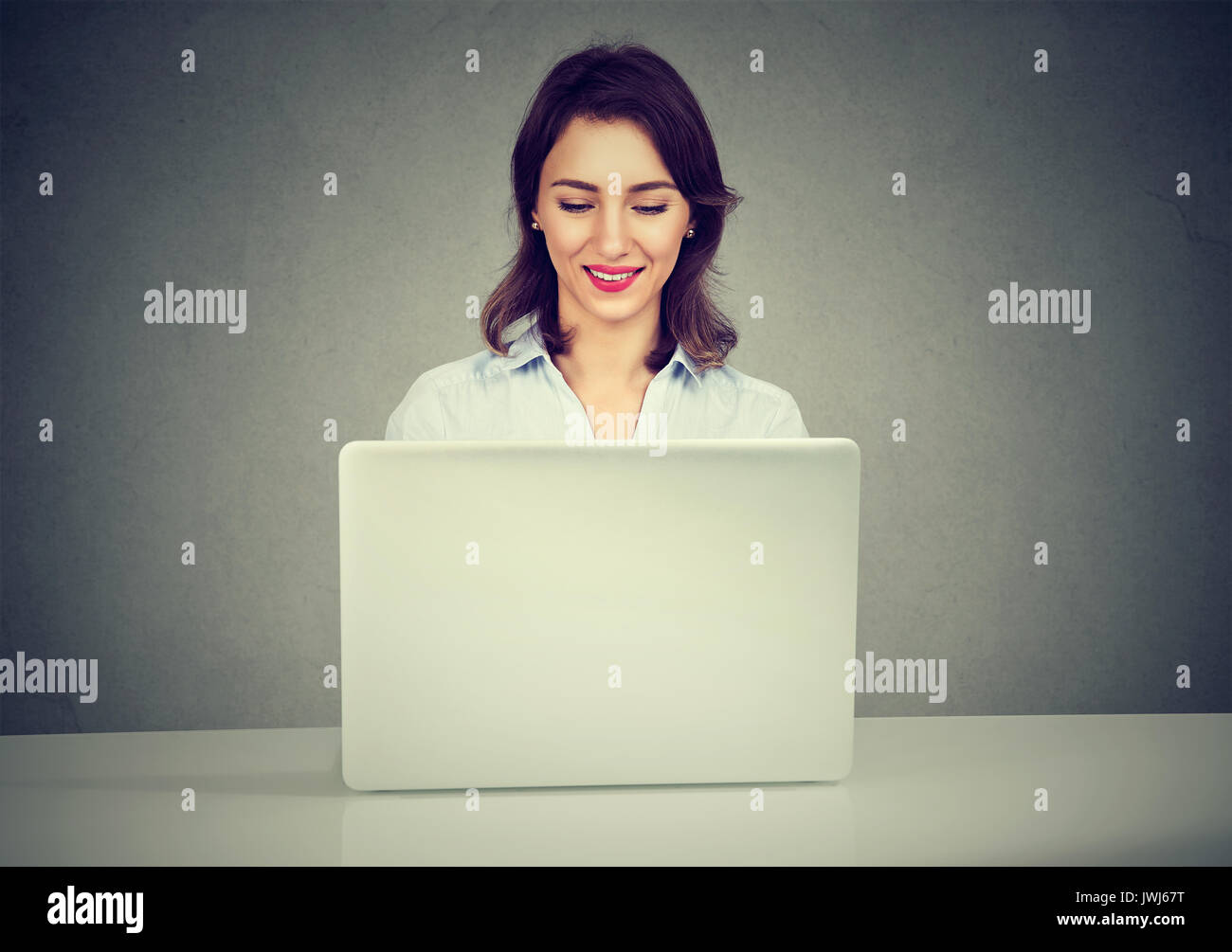 Happy business woman working on laptop computer Stock Photo - Alamy