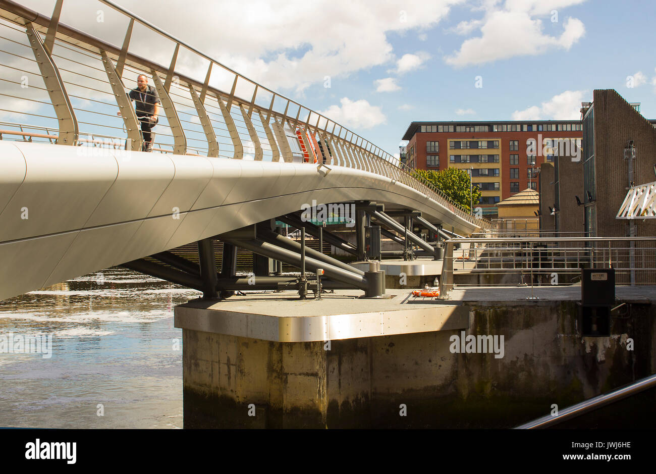 Pedestrians cross the new footbridge across the new flood barrier on ...