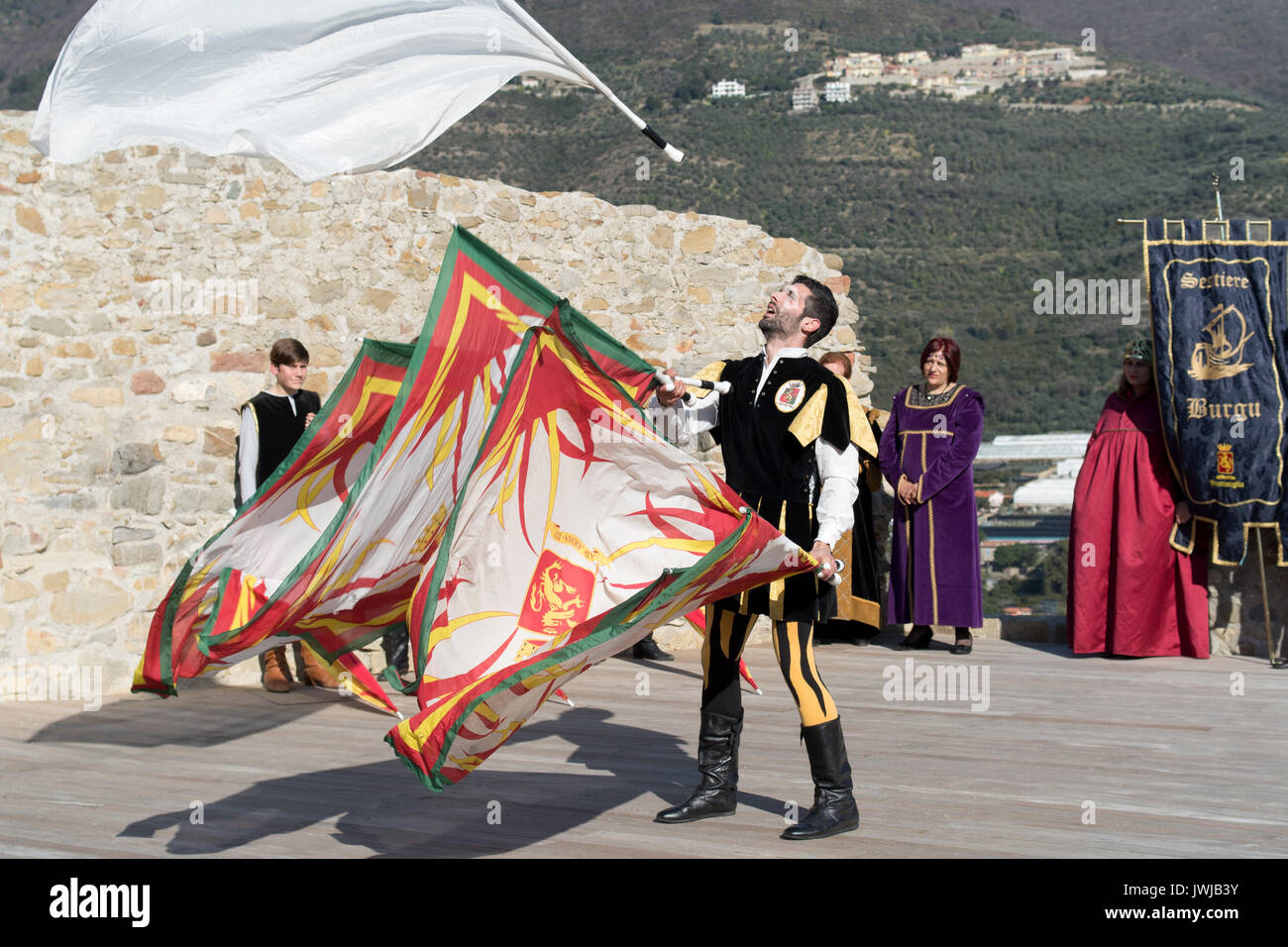Flag throwing during medieval festival in the historic city of Taggia ...
