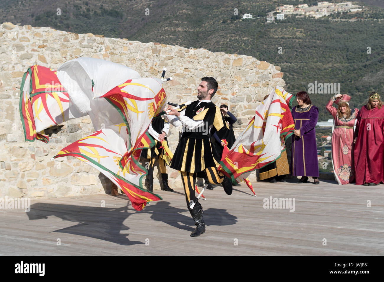 Flag throwing during medieval festival in the historic city of Taggia ...