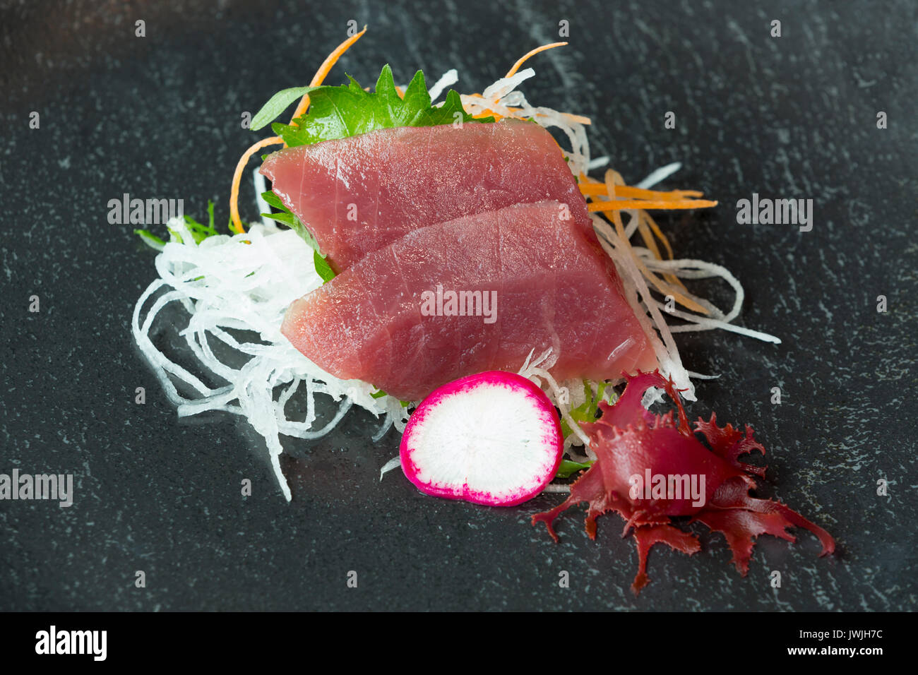 Raw tuna slices on shredded vegetables Stock Photo - Alamy