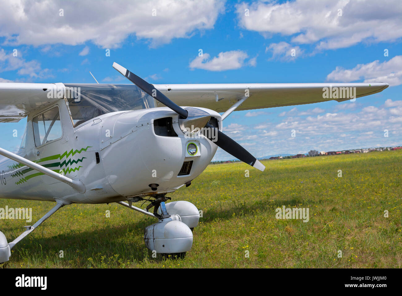 Small white airplane in the grassy field Stock Photo - Alamy