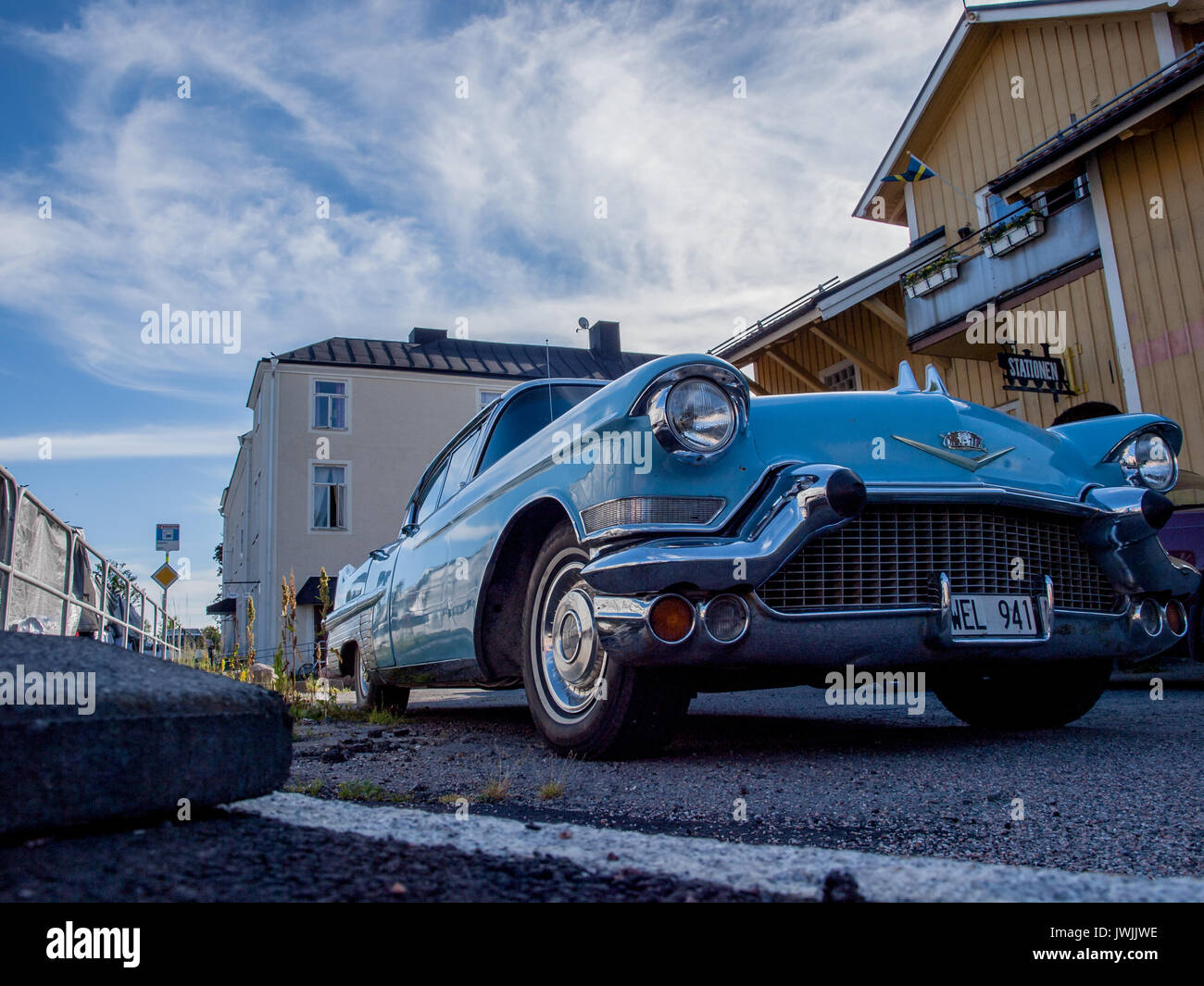 Bright blue Cadillac car parked in front of buildings Stock Photo - Alamy