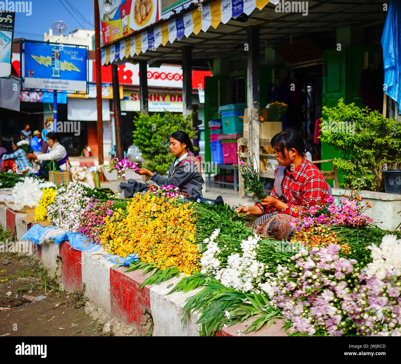 Yangon, Myanmar - Oct 17, 2015. Vendors selling flowers at the rural ...