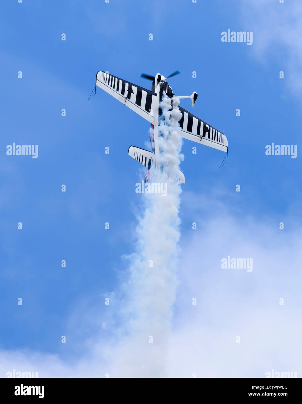 Xtreme Air XA41 aerobatic aircraft climbing vertically and trailing ...