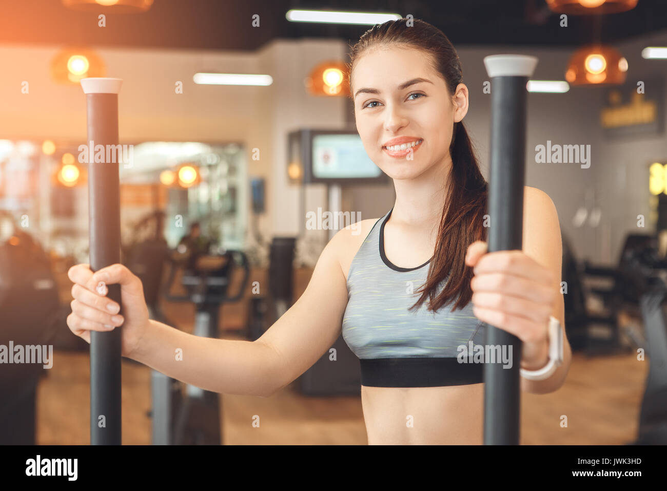 Female training in gym body workout elliptical trainer Stock Photo - Alamy