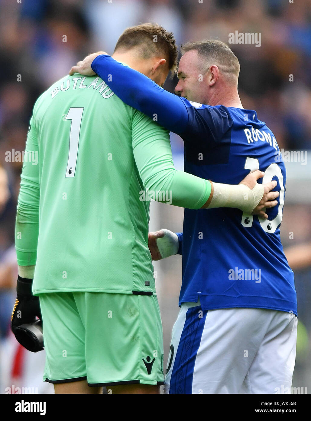 Stoke City goalkeeper Jack Butland (left) and Everton's Wayne Rooney ...