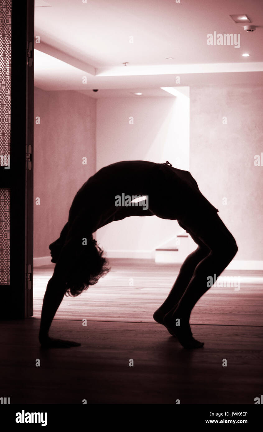 Yoga teacher doing backbend bridge flexibility and strength asana ...