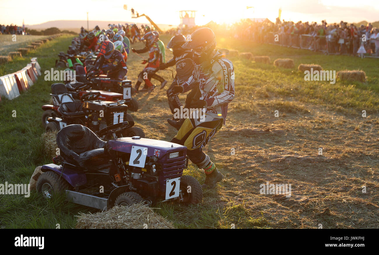 Competitors take part in a 'Le Mans' style mass start as the flag is ...