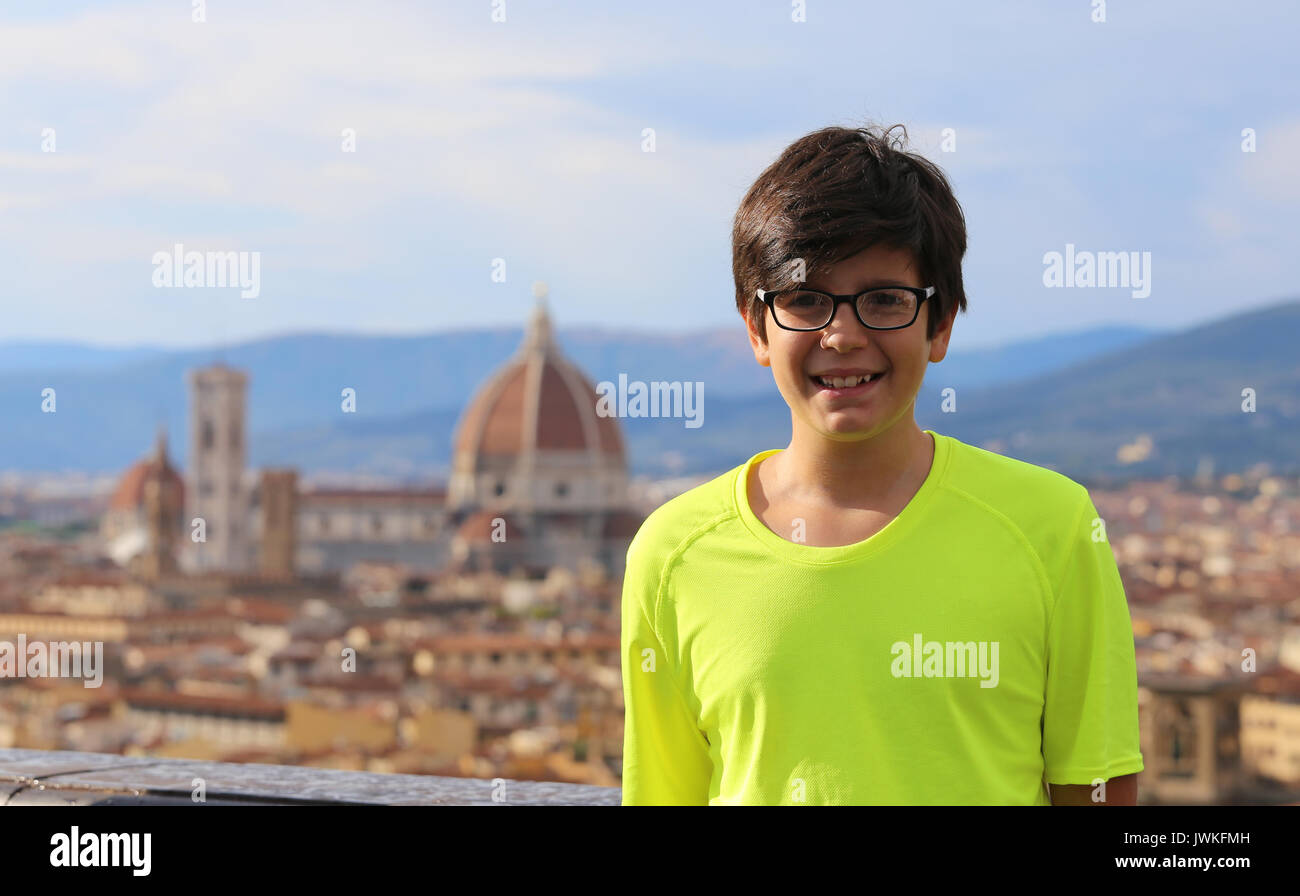 Smiling boy with long hair and the background of the city of FLORENCE ...
