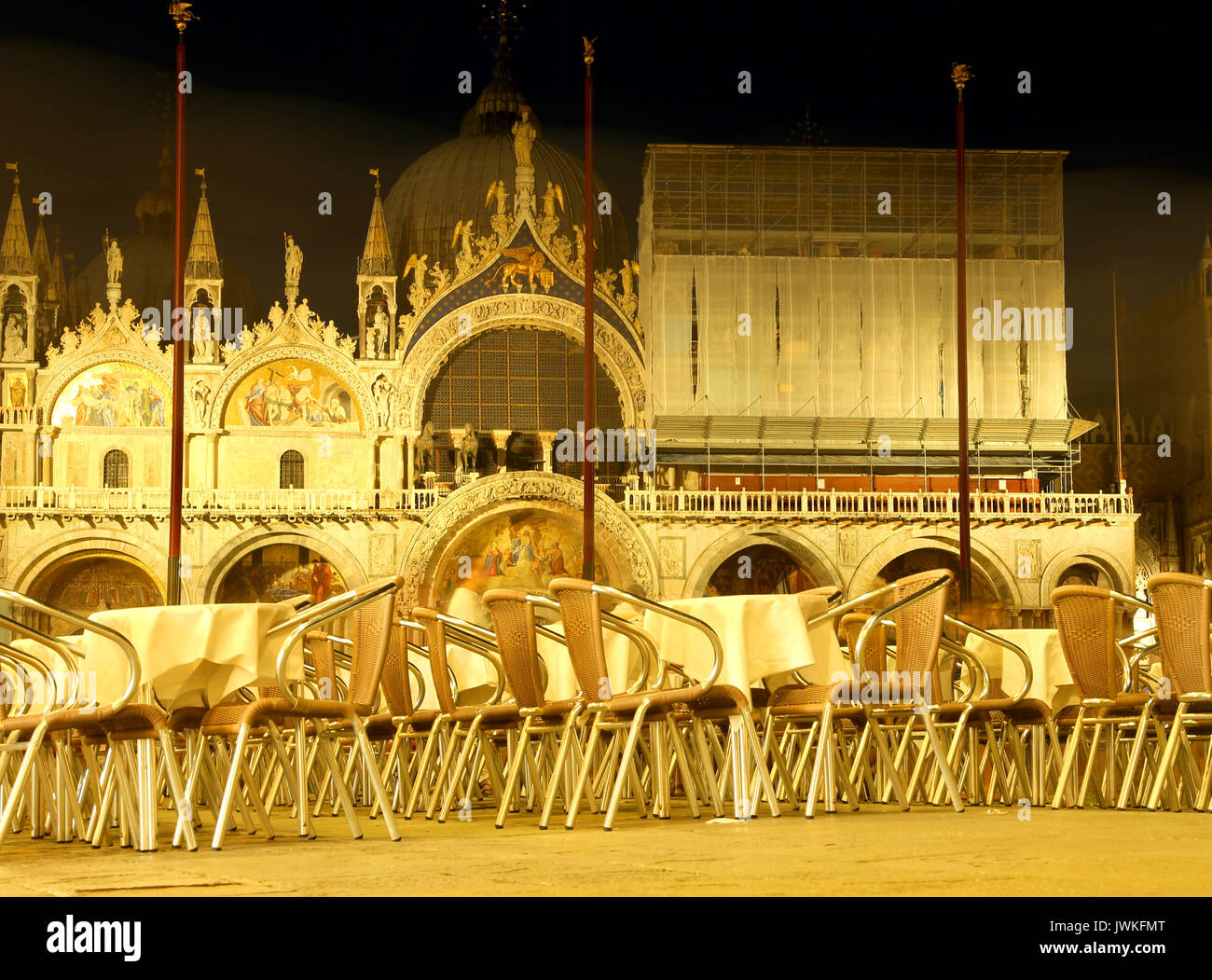 Venice in Italy by night Basilica of Saint Mark and tables with chairs ...