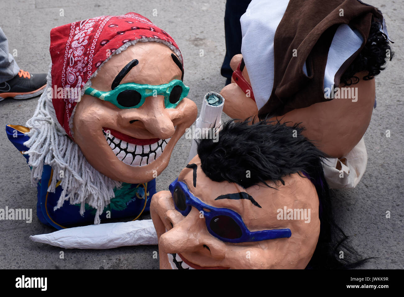 Masks are pictured put down on the street. Hundreds of people are seen ...