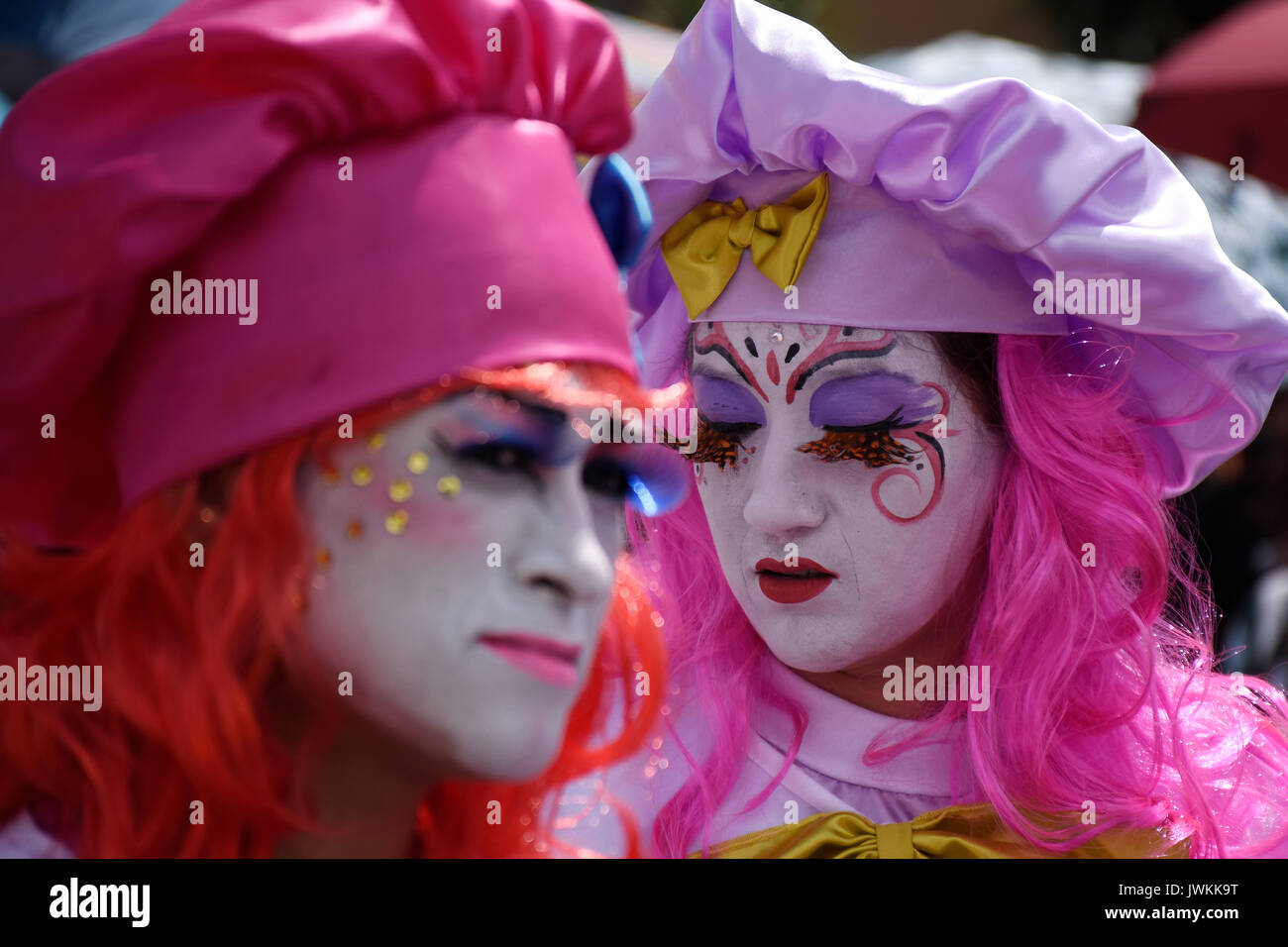 Participants dressed in colourful bizarre costume are walking though ...