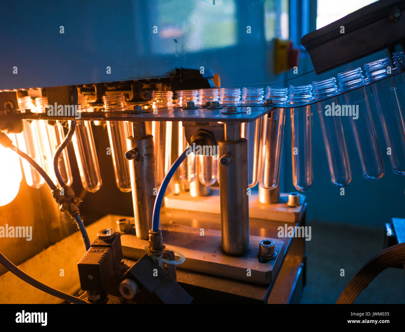 rows of empty plastic bottles at bottling plant. Production of small ...