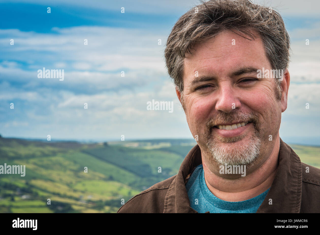 Irish Man Smiling with Pastures in Background Stock Photo - Alamy
