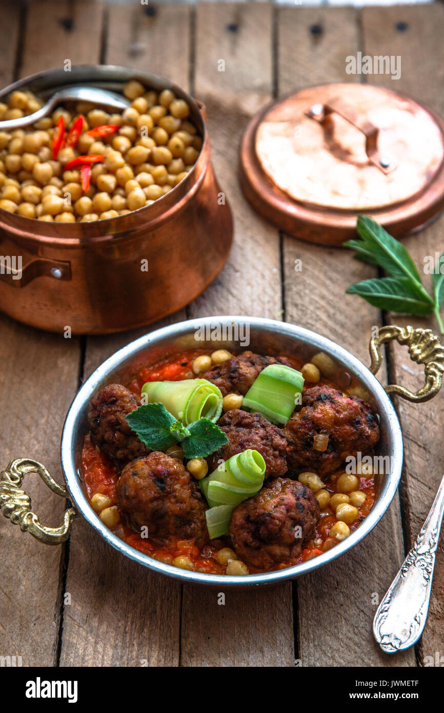 izmir kofte, Turkish traditional meatballs in copper pan with spicy ...
