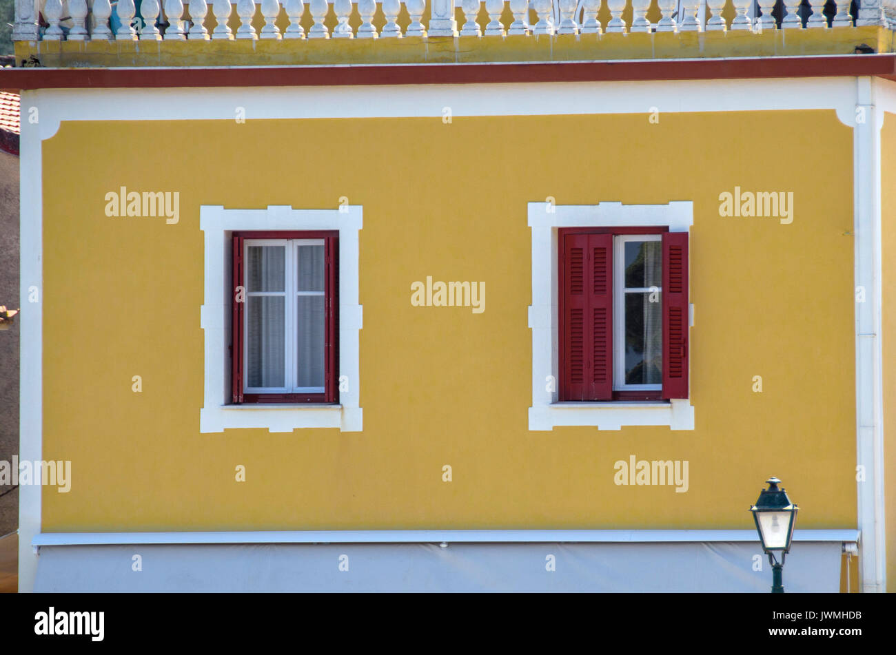 Two windows on yellow house Stock Photo - Alamy