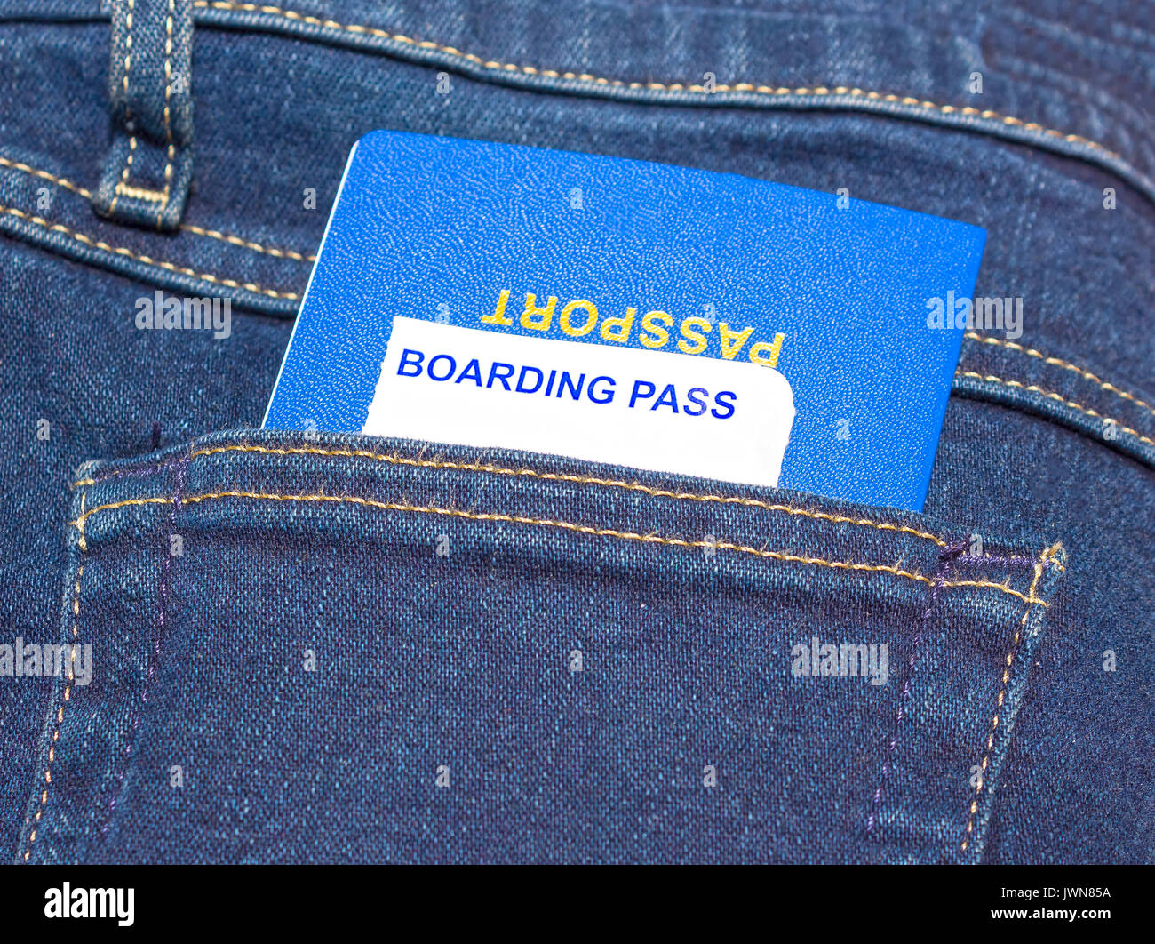 Passport and boarding pass sticking out of jeans pocket Stock Photo - Alamy