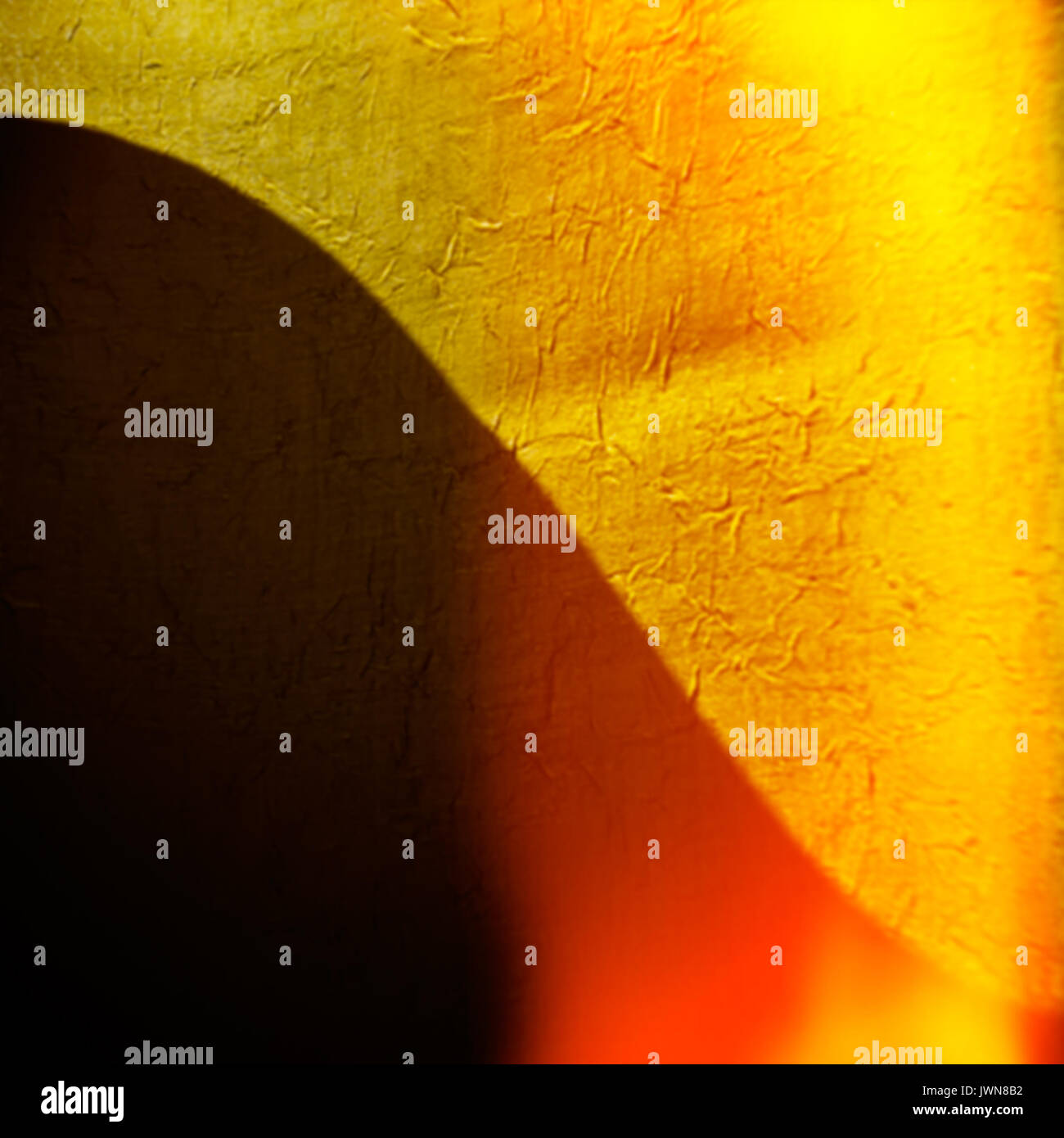 Blurred background yellow fabric and curved shadow Stock Photo - Alamy
