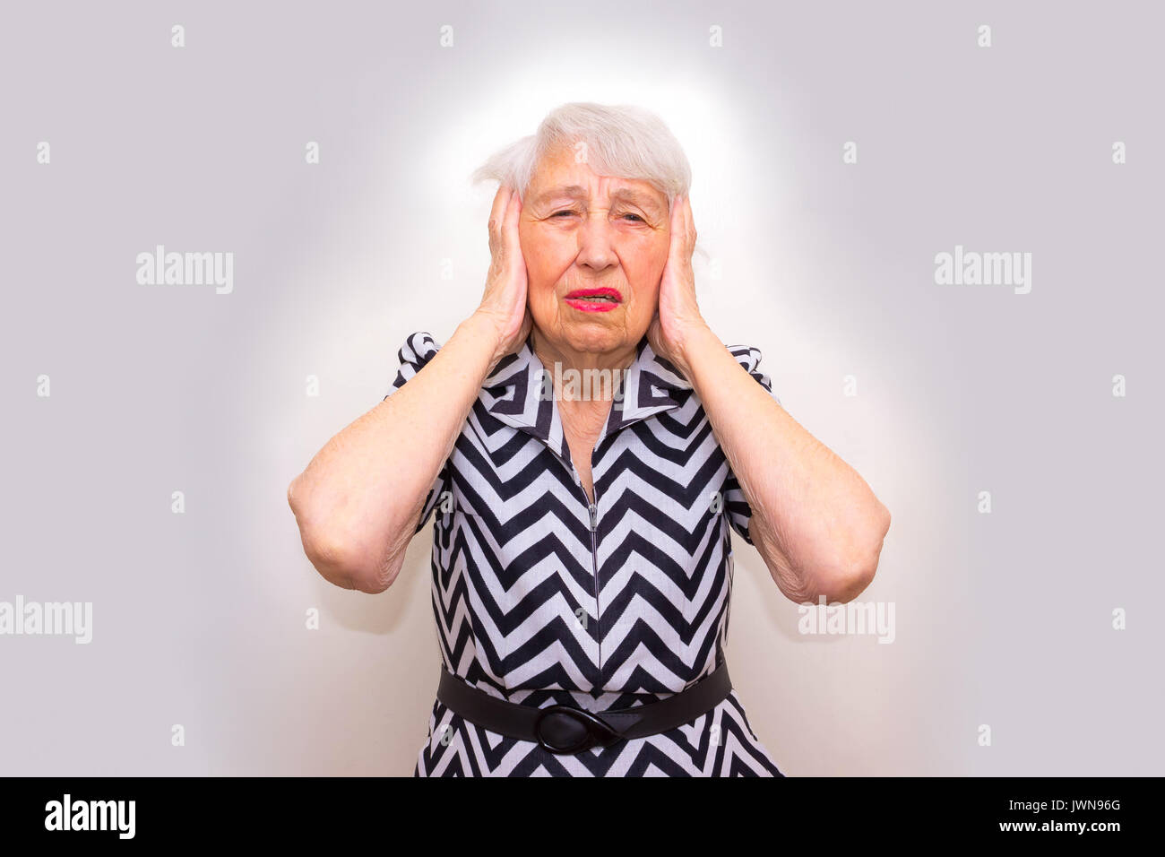Senior Woman With Head In Hands Looking Weary Stock Photo - Alamy