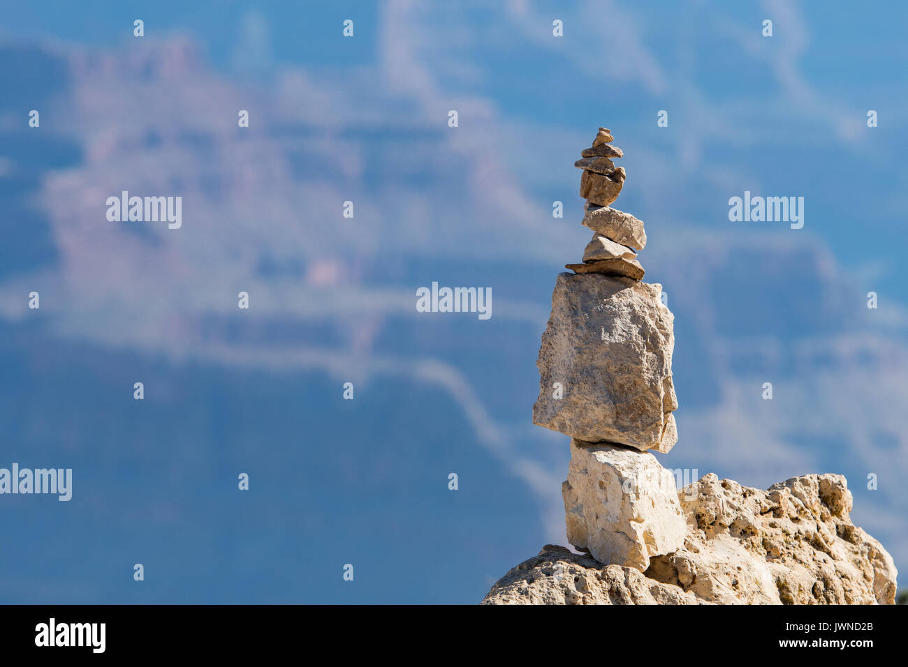 Thin Rocks in Cairn Stack with grand canyon blurred in the background ...