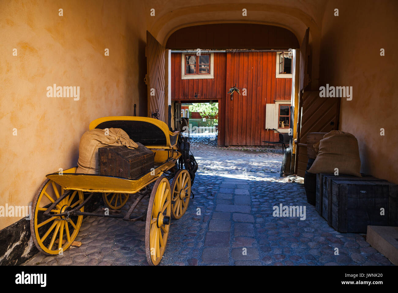 Vintage yellow wooden coach in old yard, Scandinavian style Stock Photo ...