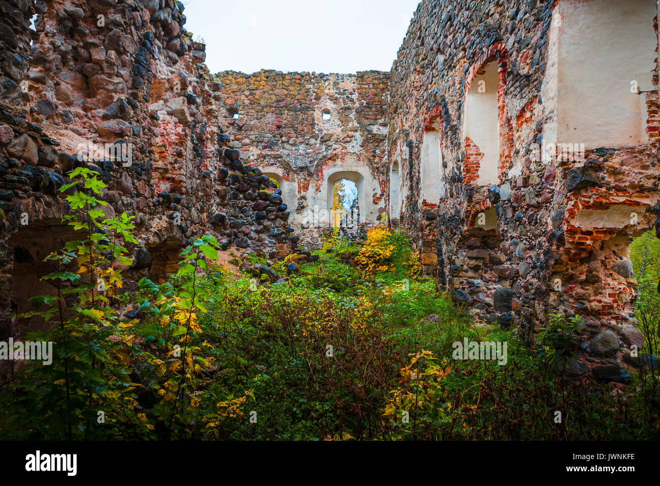 Medieval stone granite castle ruins at fall time. Autumn foliage. Rauna ...