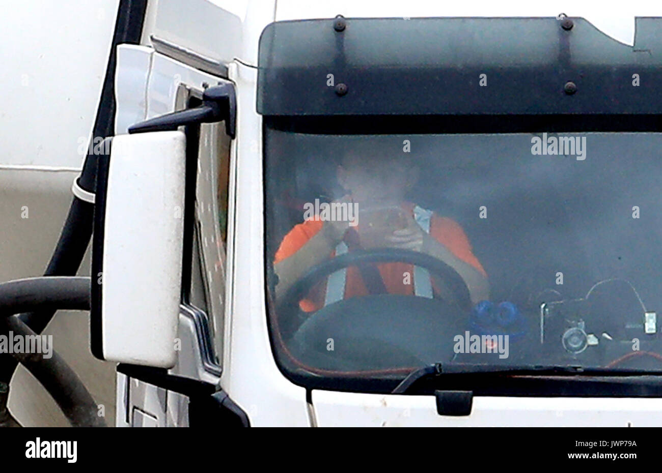 A lorry driver eats his lunch at the wheel as he drives along the M20 ...