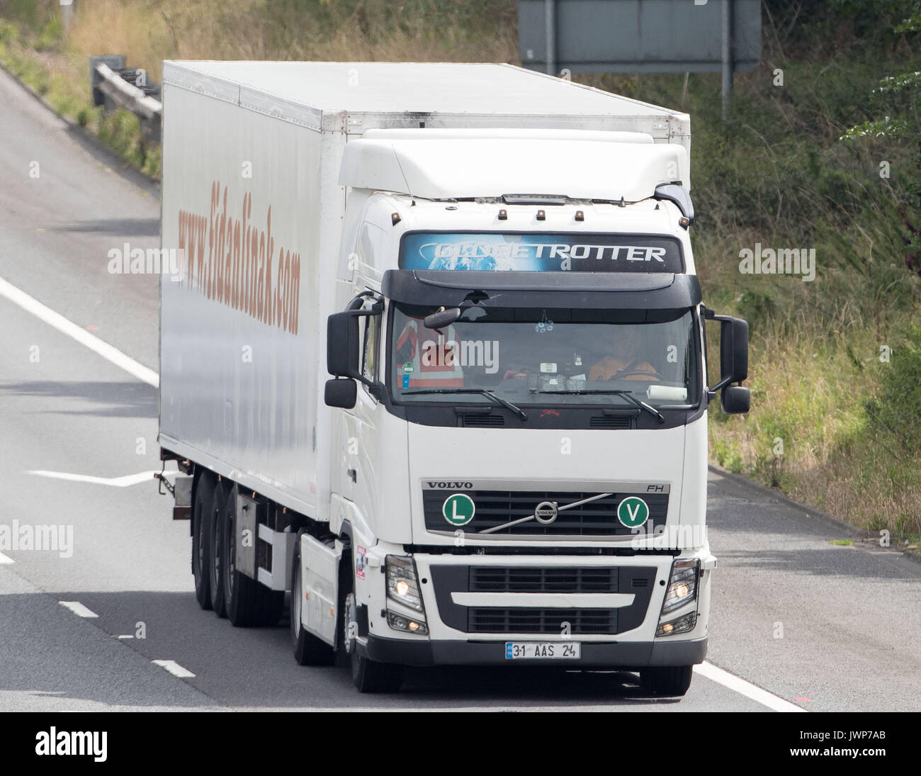 A lorry driver uses a mobile phone as he drives along the M4 near ...