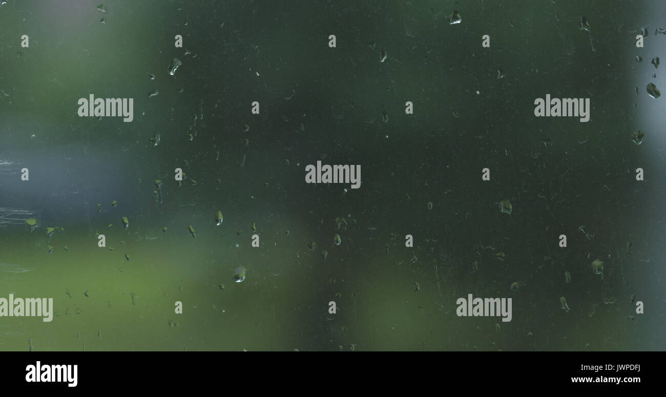 first rain drops on dirty window, wide photo Stock Photo - Alamy