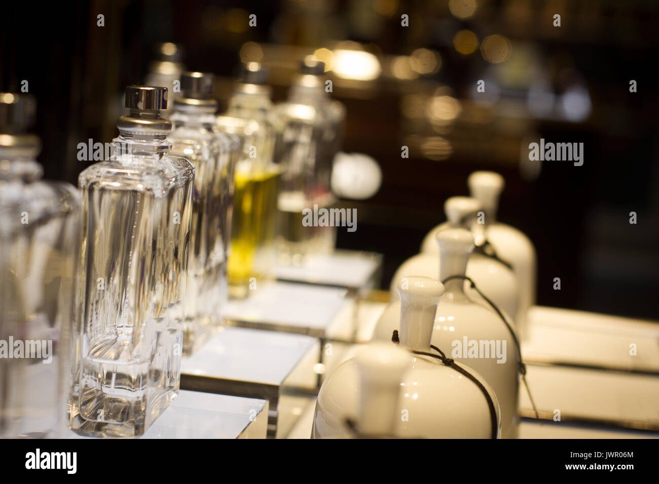 perspective view of white ceramic fragrance bells and perfume bottles ...