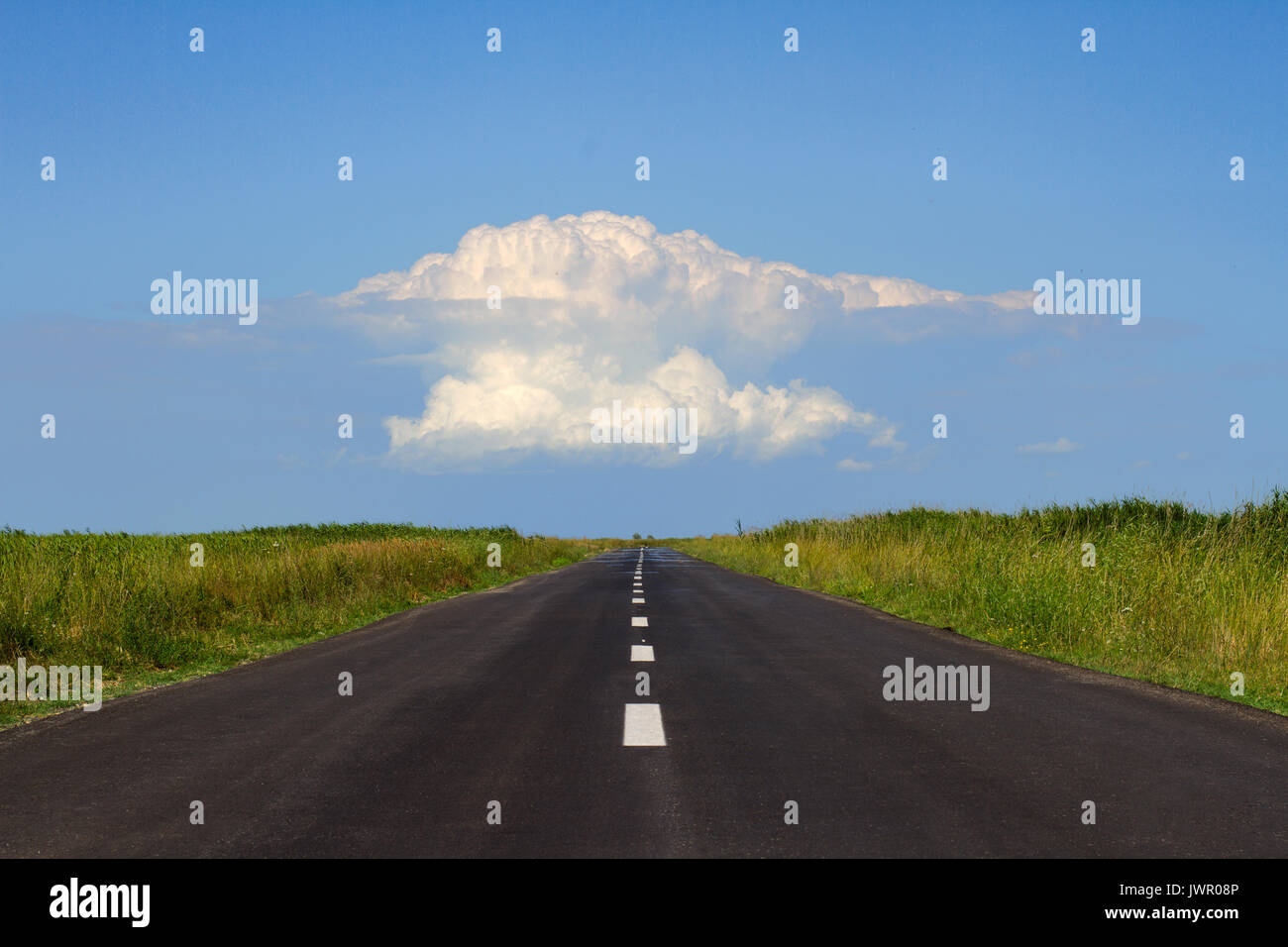 horizontal perspective view of black asphalt road with a large white ...