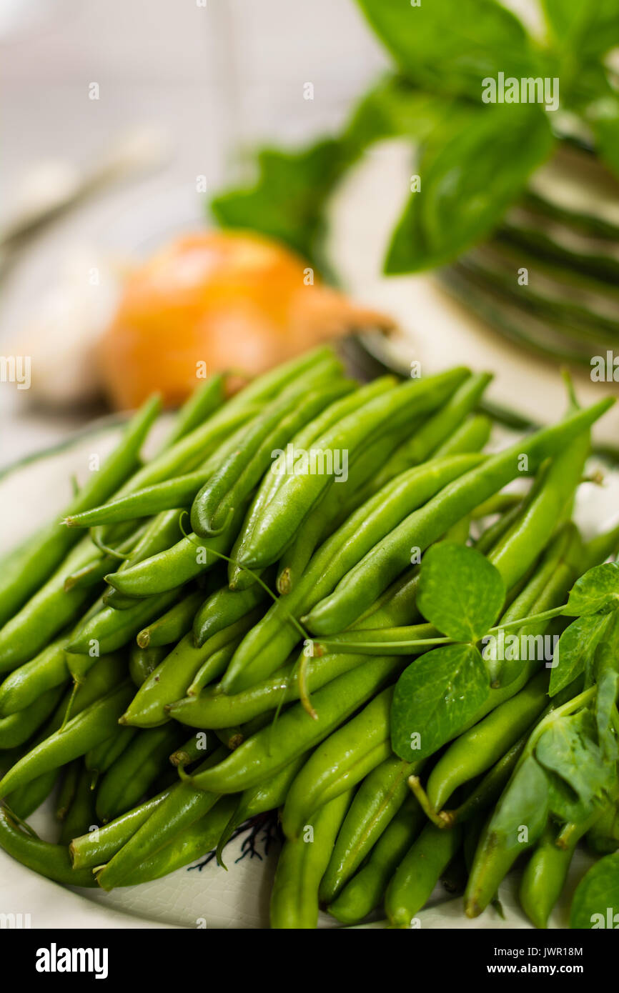 Fresh green snap beans on the plate ready to cook, healthy food Stock ...