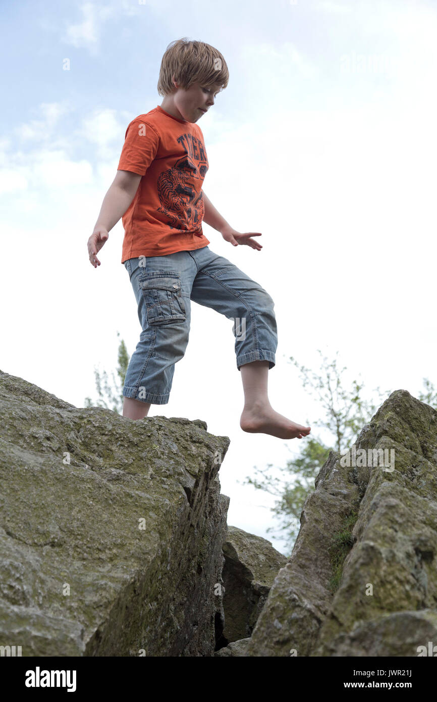 boy walking on rocks Stock Photo - Alamy
