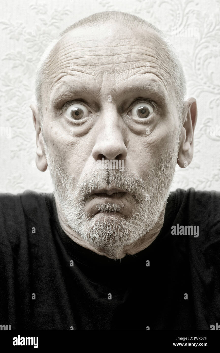 Portrait of a surprised and angry caucasian man with a penetrating gaze ...