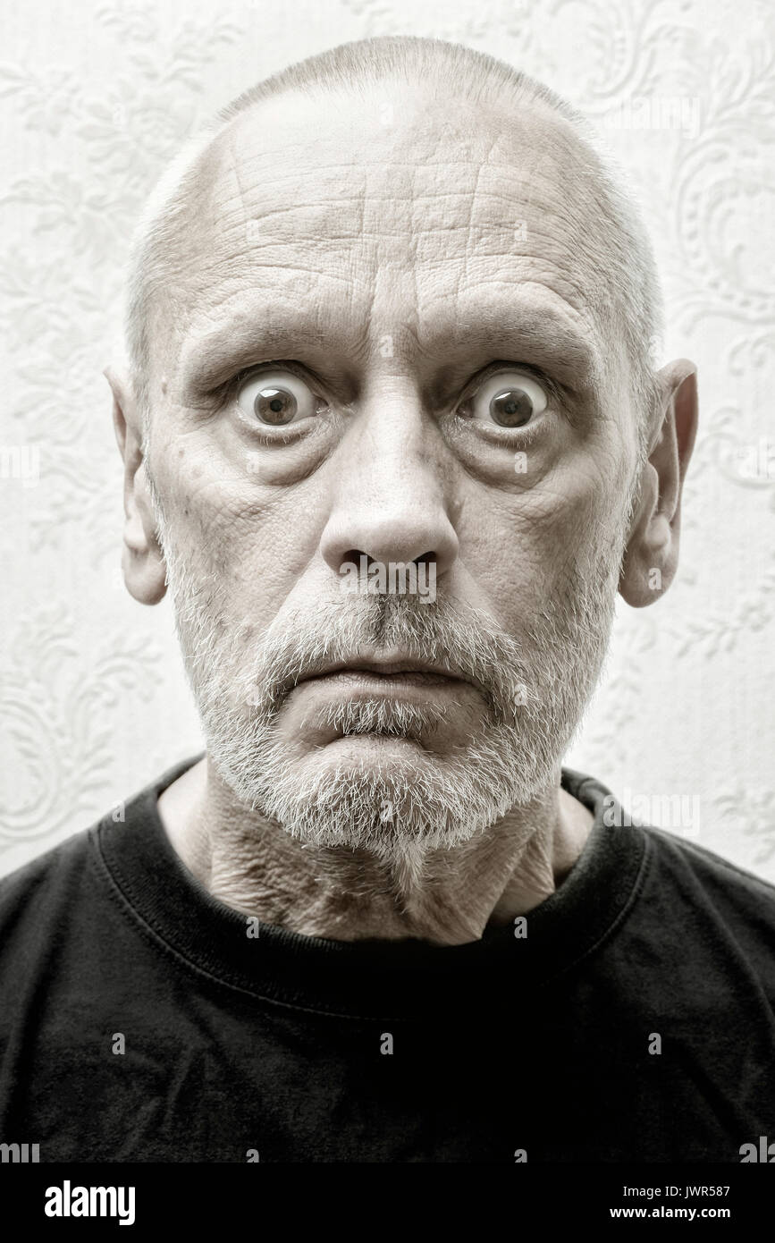 Portrait of a surprised and angry caucasian man with a penetrating gaze ...