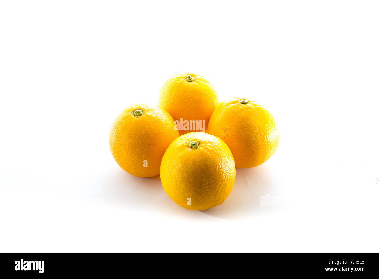 Four orange isolated on a white Stock Photo - Alamy