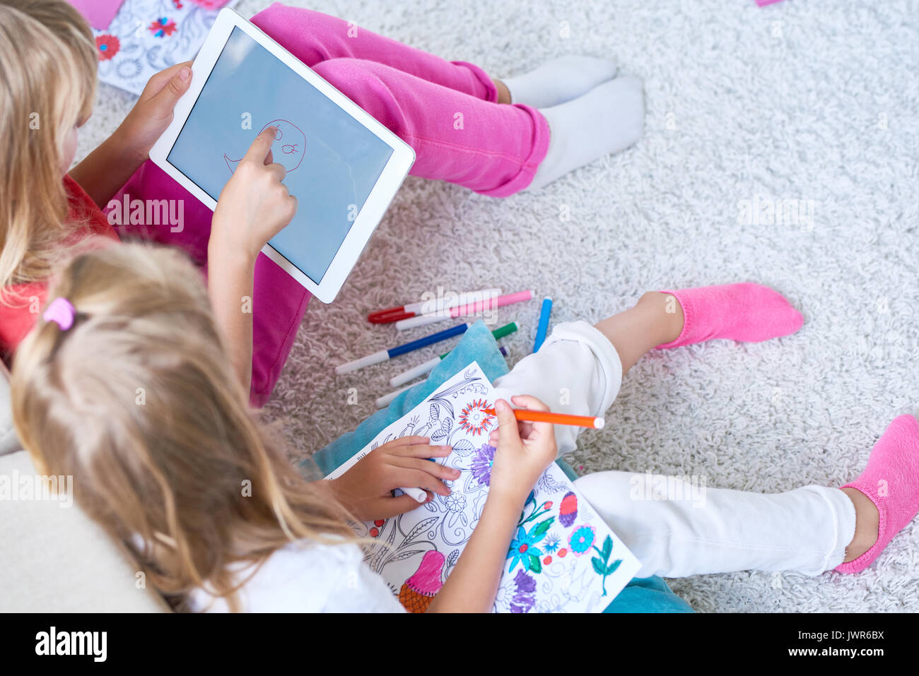 High angle view of unrecognizable little girl drawing stick figure on ...