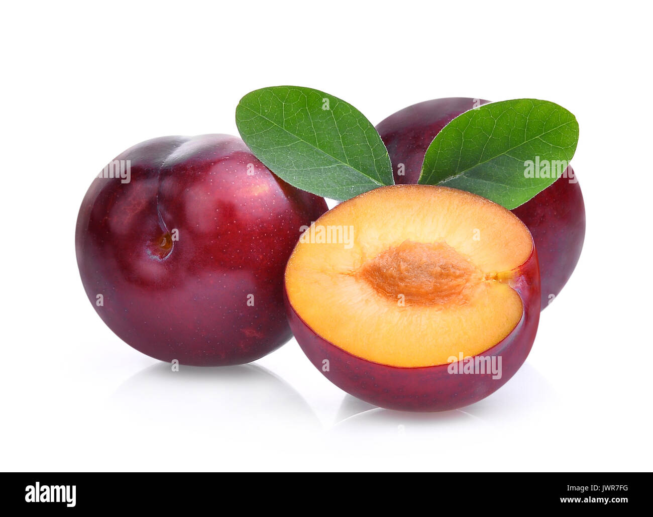 red cherry plum, tropical fruit with green leaves isolated on white ...