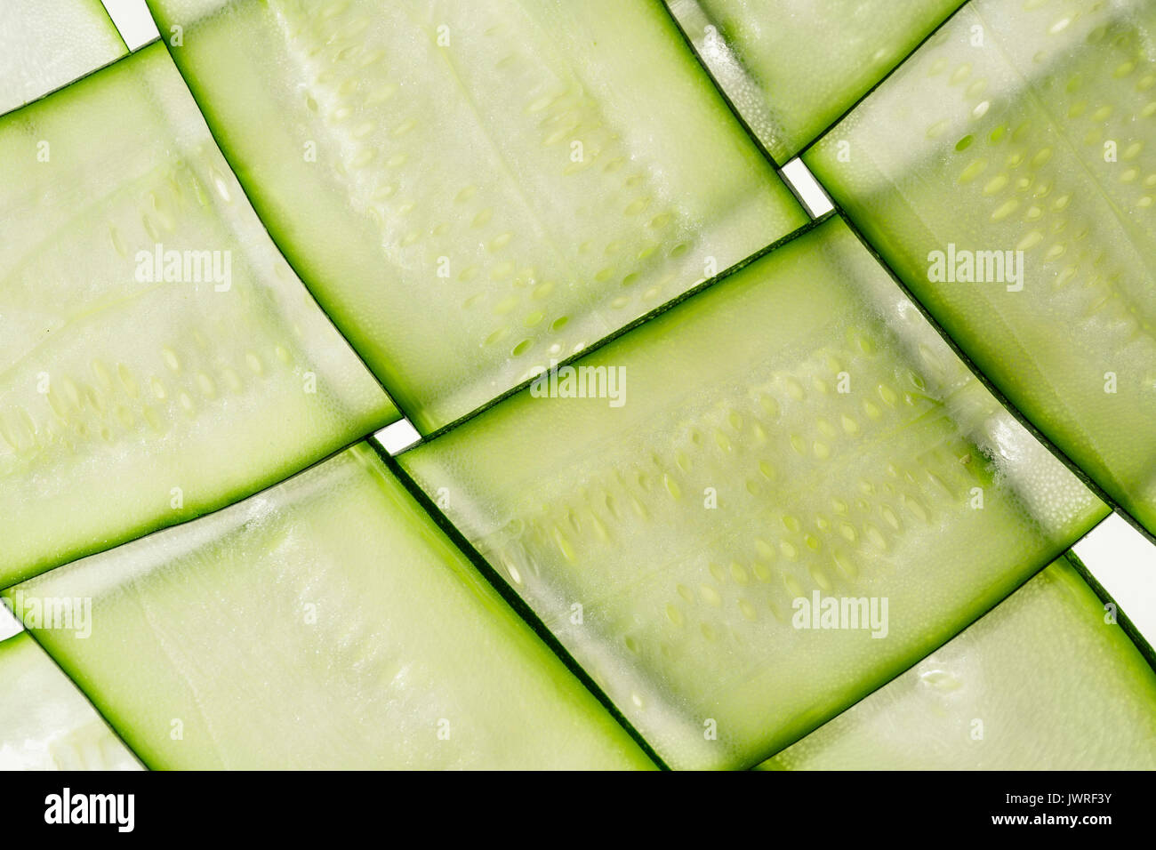 Slices of fresh Courgette on white background Stock Photo - Alamy