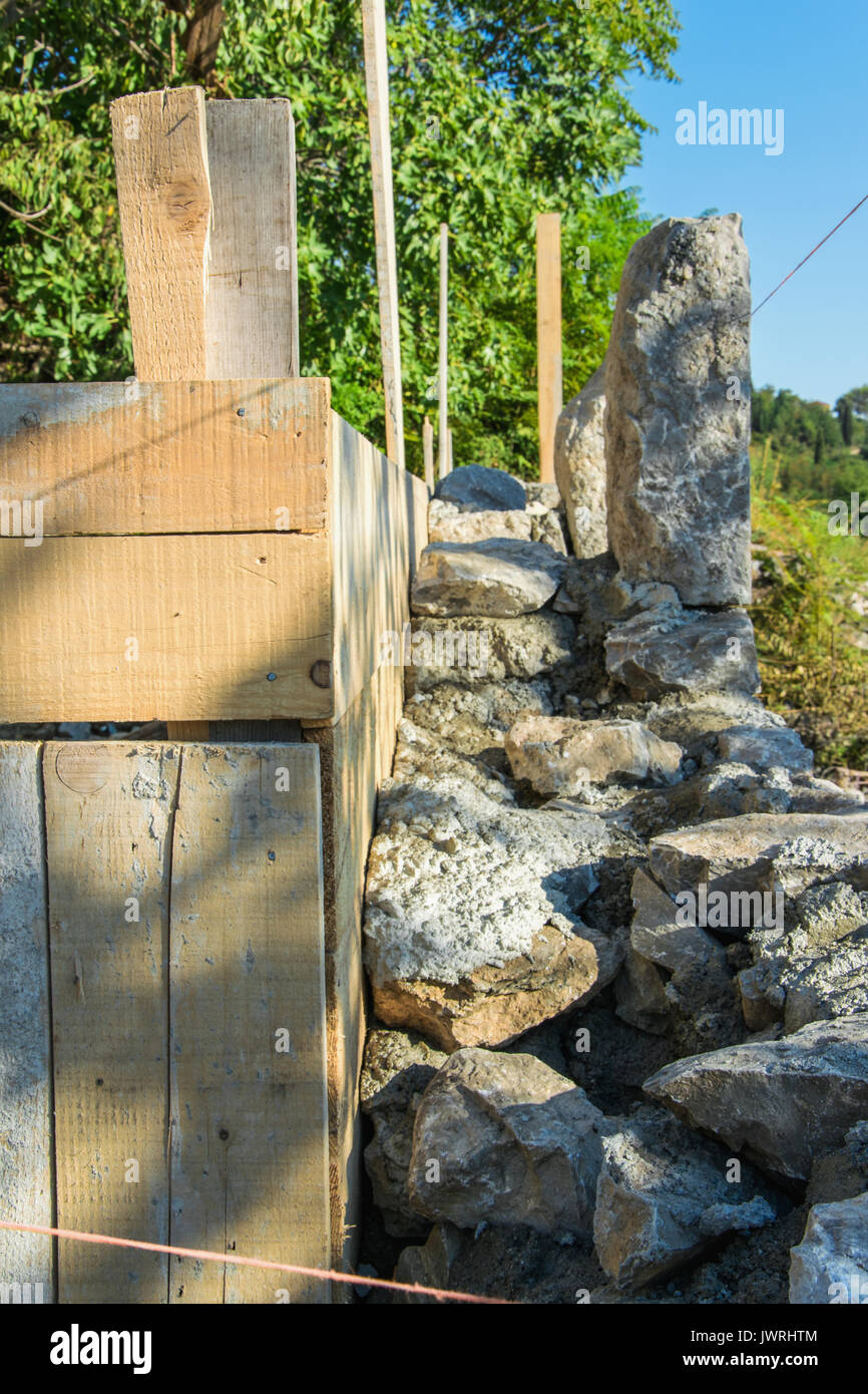 Stone wall construction Stock Photo - Alamy
