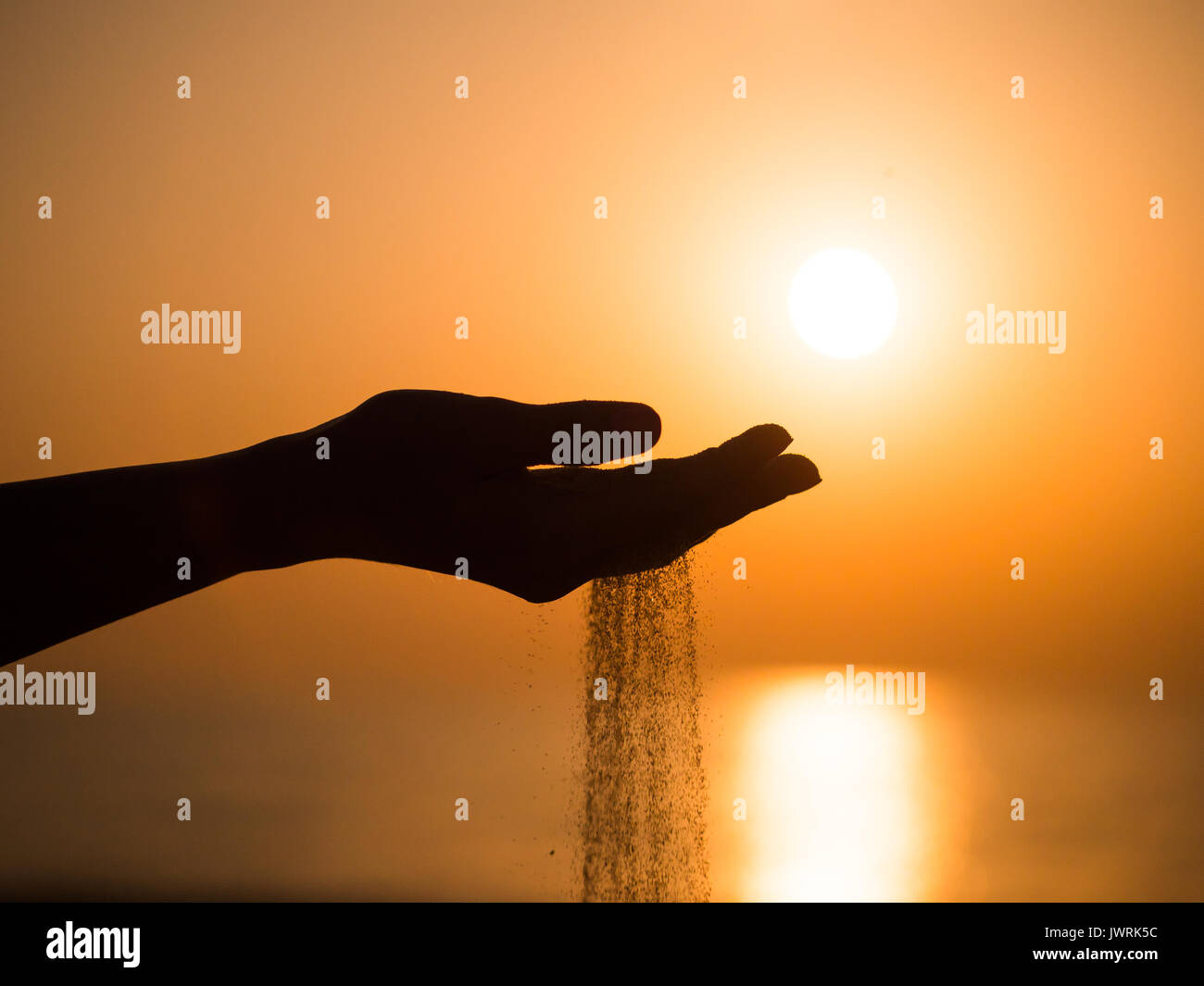 Hand pouring sand hi-res stock photography and images - Alamy