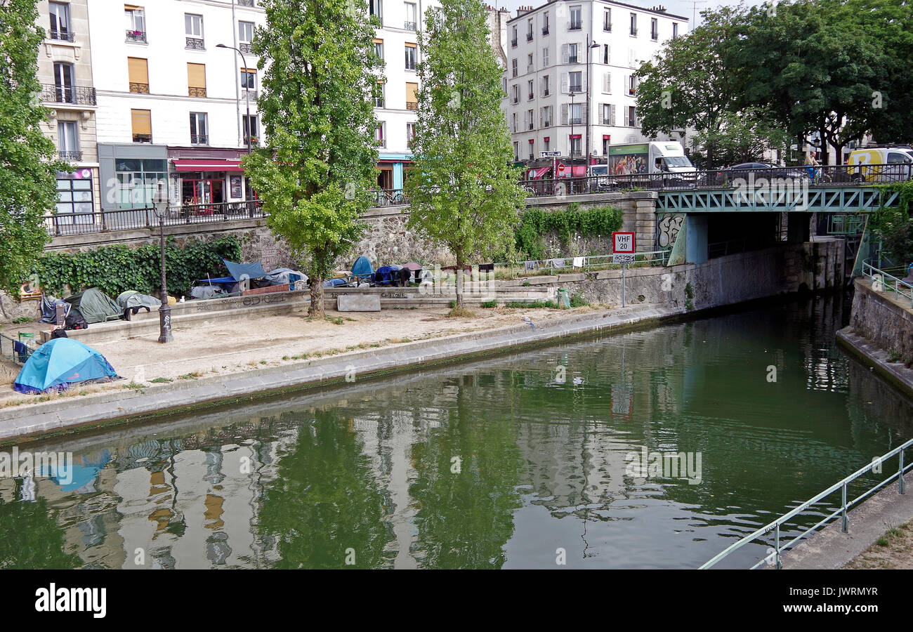 Small tented encampment of homeless people on a piece of land beside ...