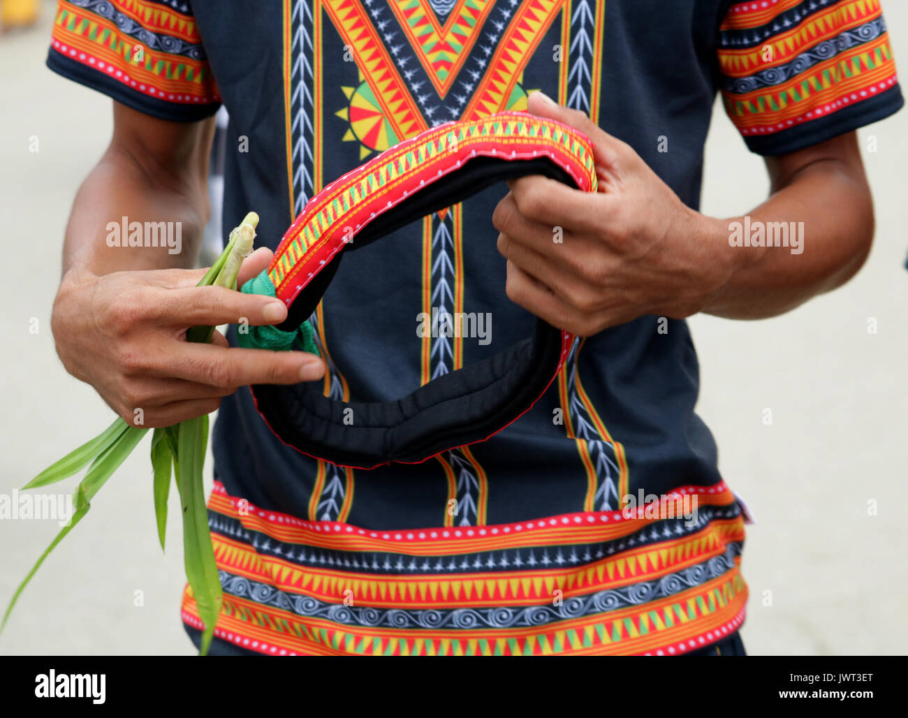 Blangkejeren, Indonesia. 13th Aug, 2017. A dancer holds a teleng and ...