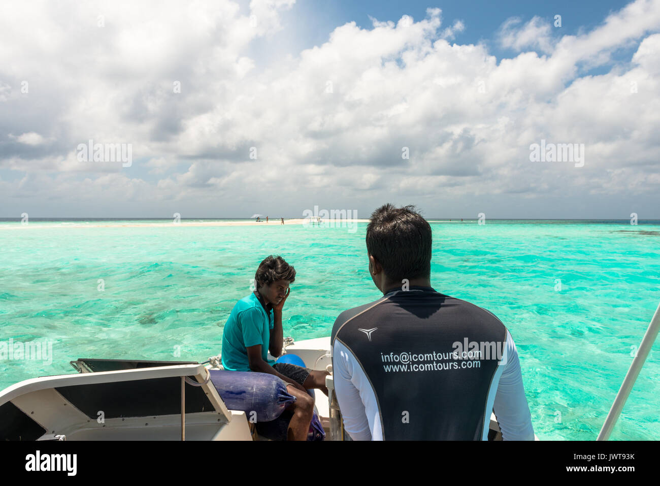 MAAFUSHI, MALDIVES - FEBRUARY 29, 2016: Two local Maldives men guiding ...