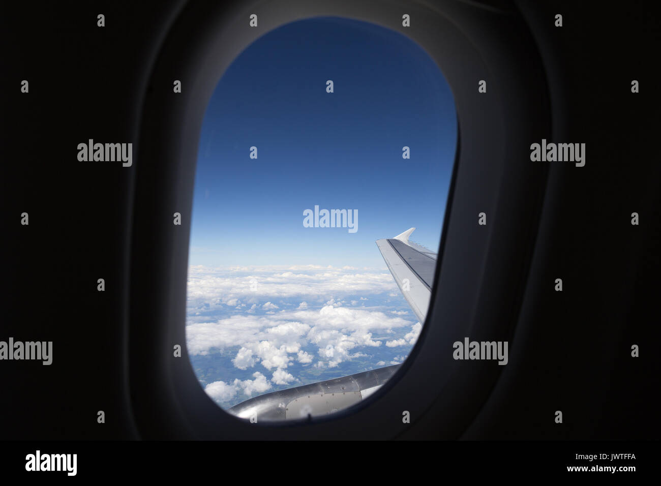 Horizontal shot of plane window with copy space. Through the window ...